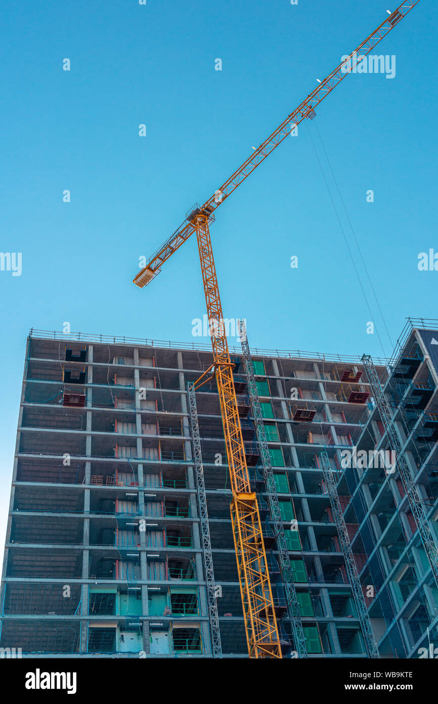 Tall building in construction. Construction site and cranes. Unfinished ...