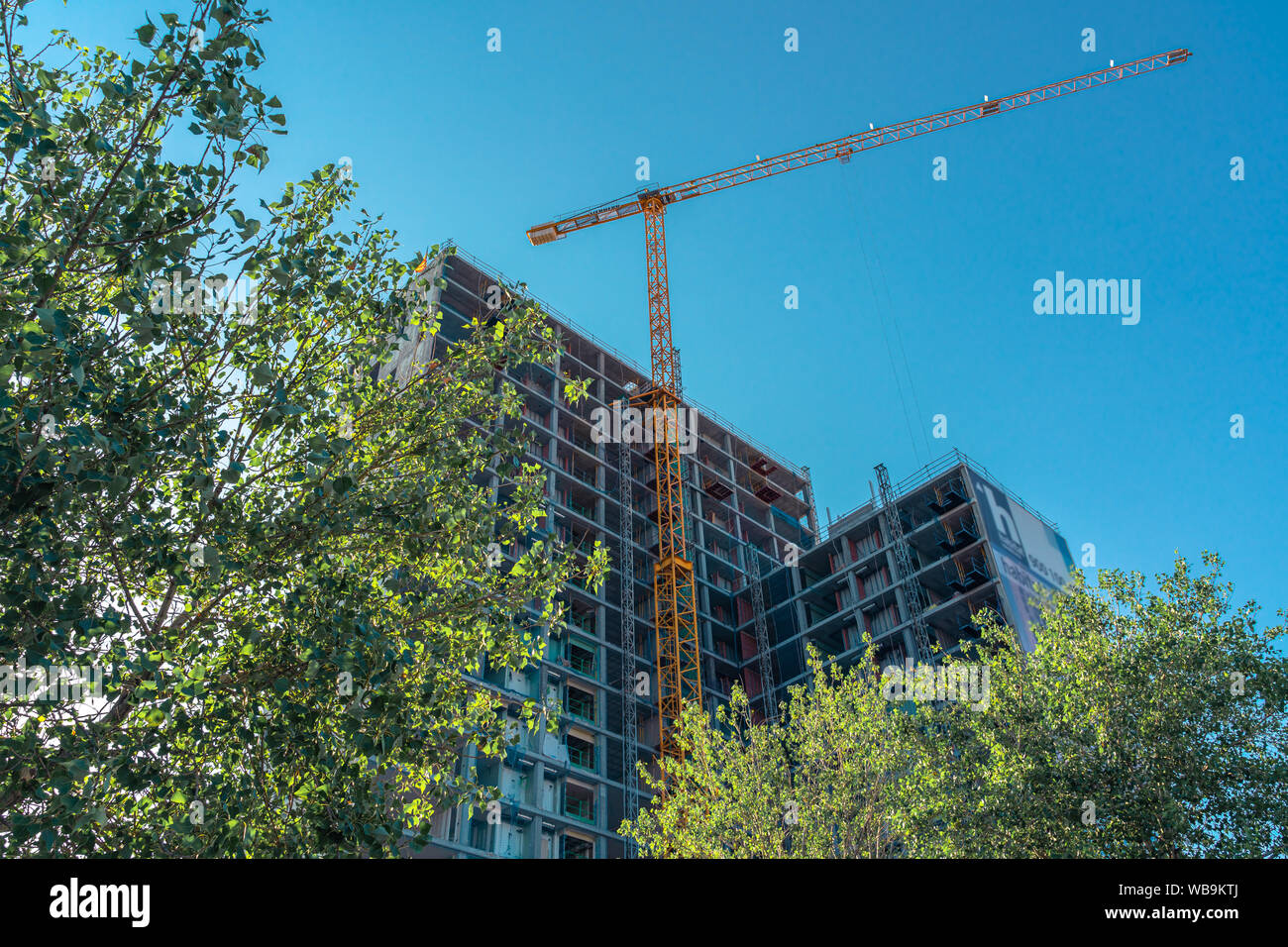 Tall building in construction. Construction site and cranes. Unfinished ...