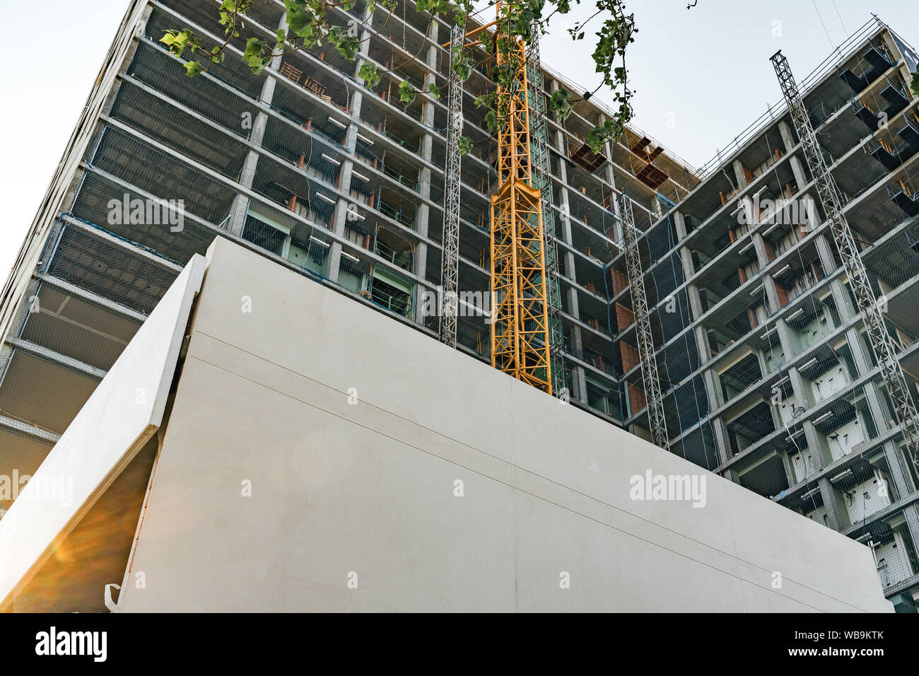 Tall building in construction. Construction site and cranes. Unfinished ...