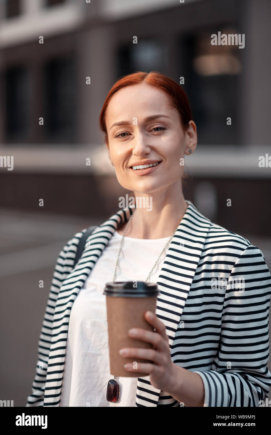 Pleased young woman looking in front of her Stock Photo - Alamy