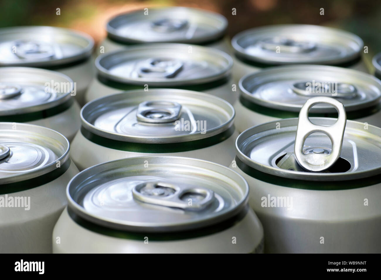 Open close-up of an aluminum can of beer on the background of a group ...