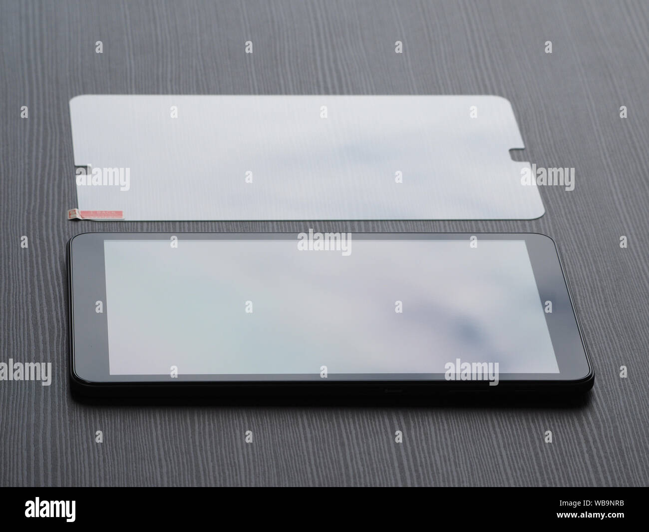 Preparation protective glass on the tablet Stock Photo - Alamy