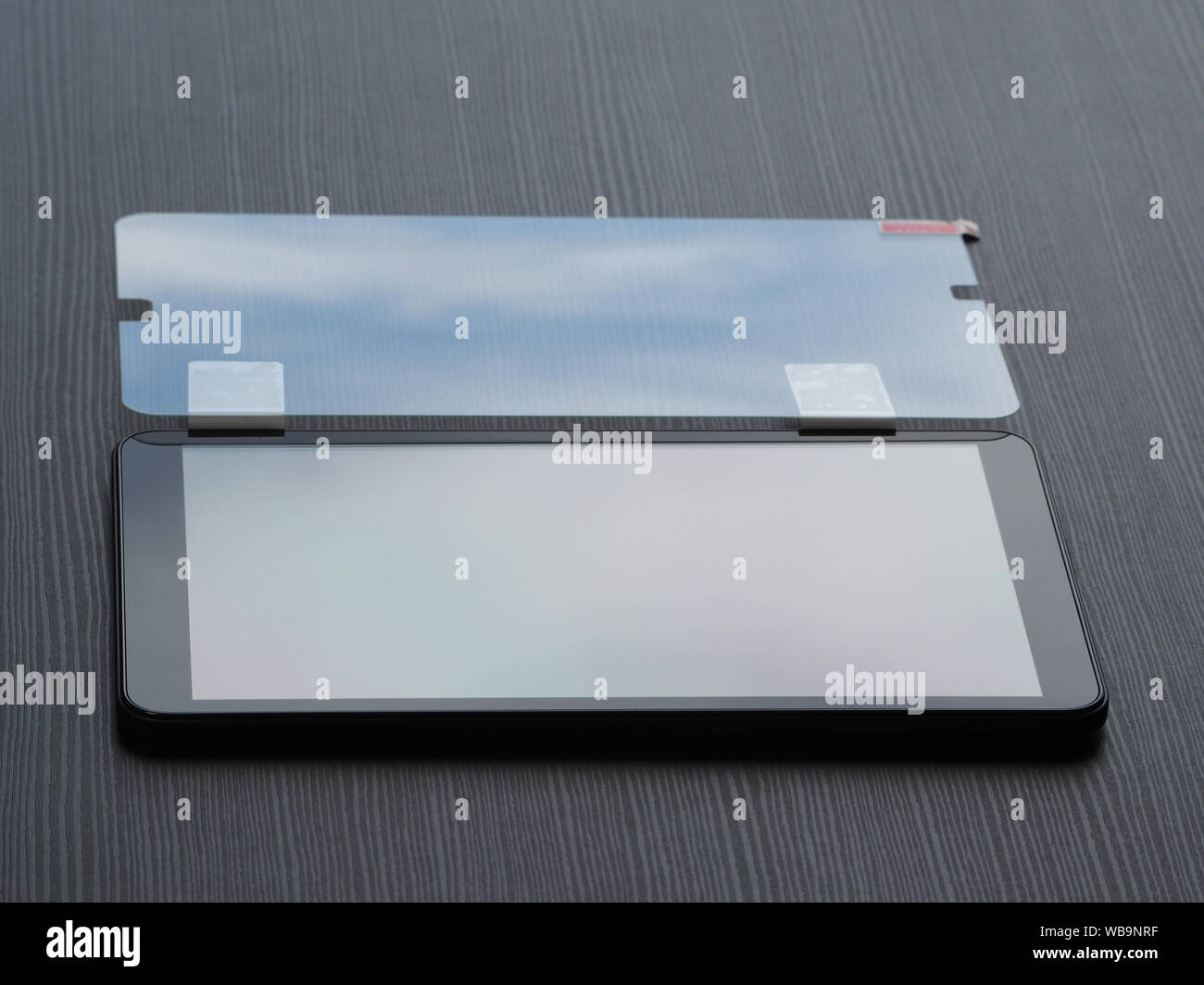 Preparation protective glass on the tablet Stock Photo - Alamy