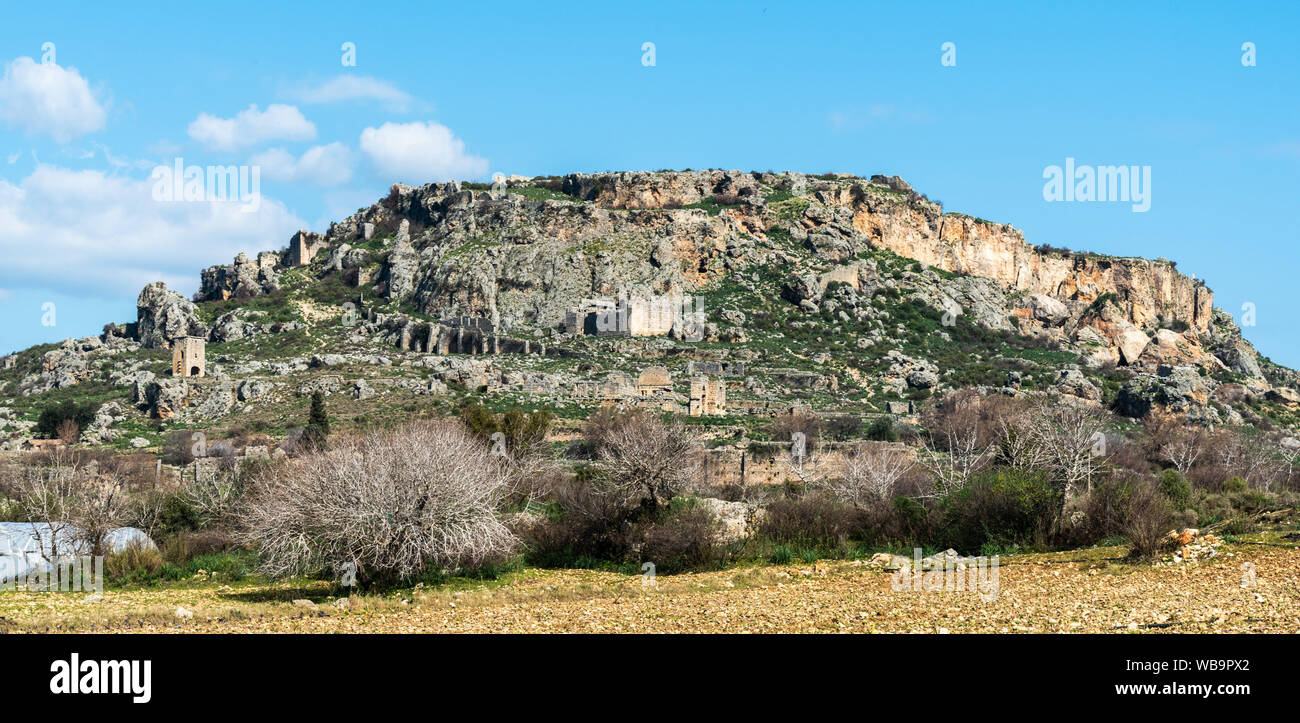 Rocky outcrop with scattered ruins of Silyon ancient city in Antalya ...