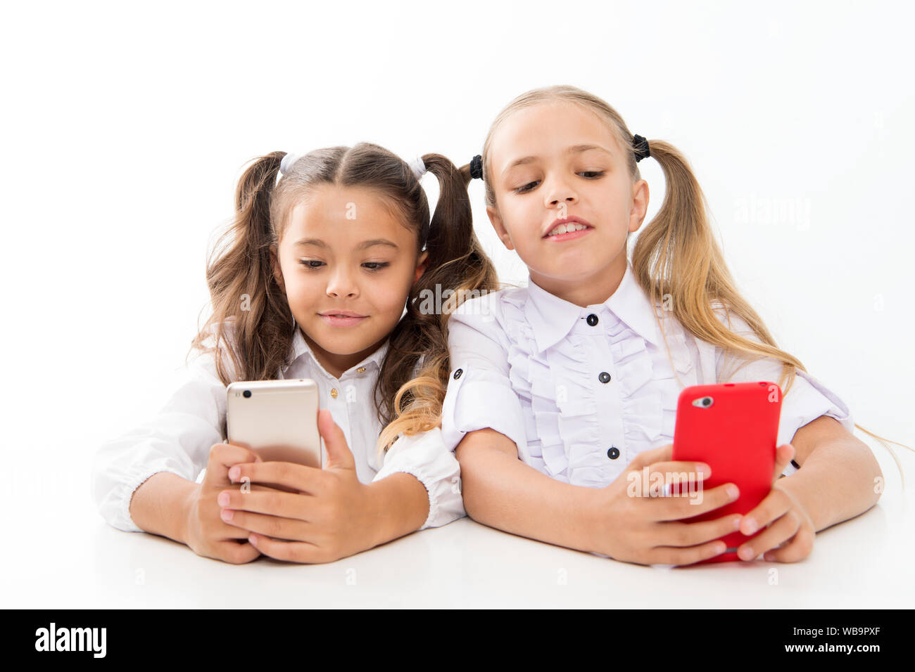 Modern students. Small students using mobile phones in classroom ...