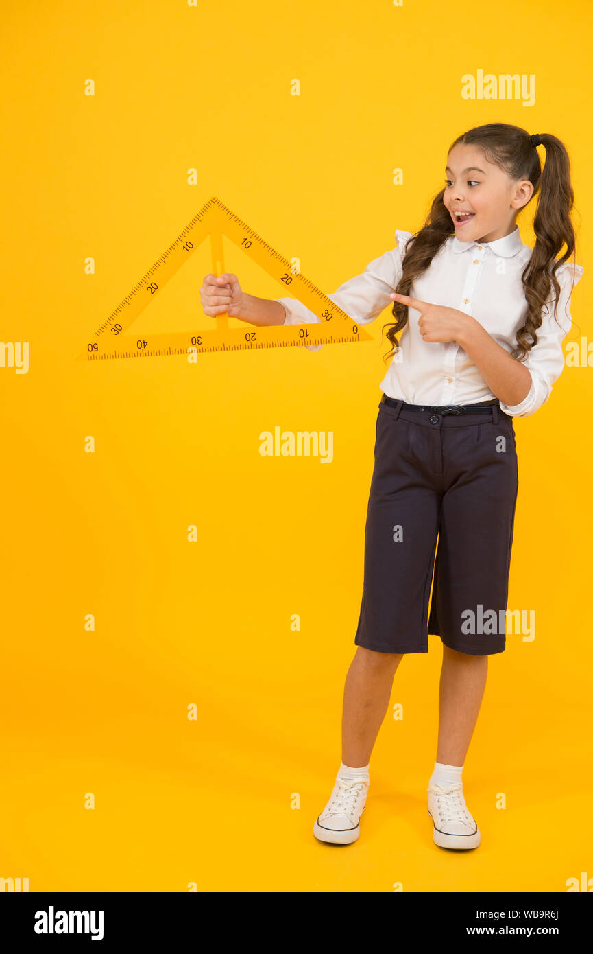 Look at the triangle with two equal sides. Happy little schoolgirl ...