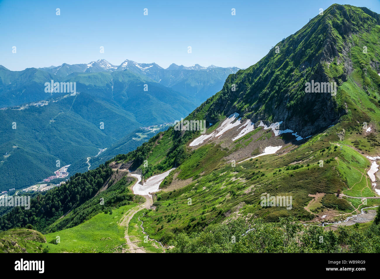 High mountains with green slopes and snowy peaks. Mountain ranges in ...