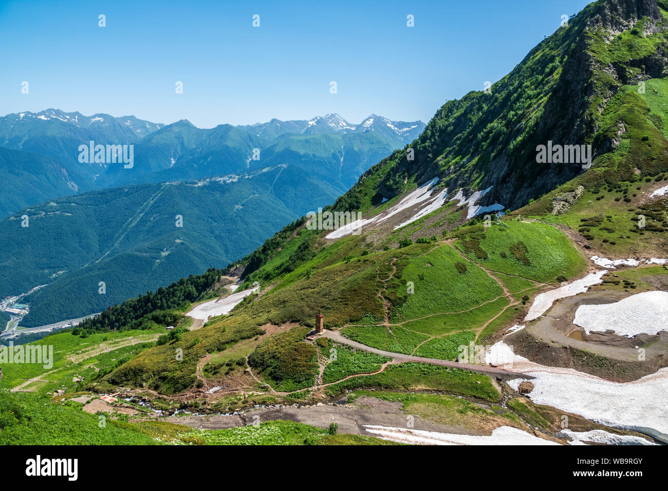 High mountains with green slopes and snowy peaks. Mountain ranges in ...
