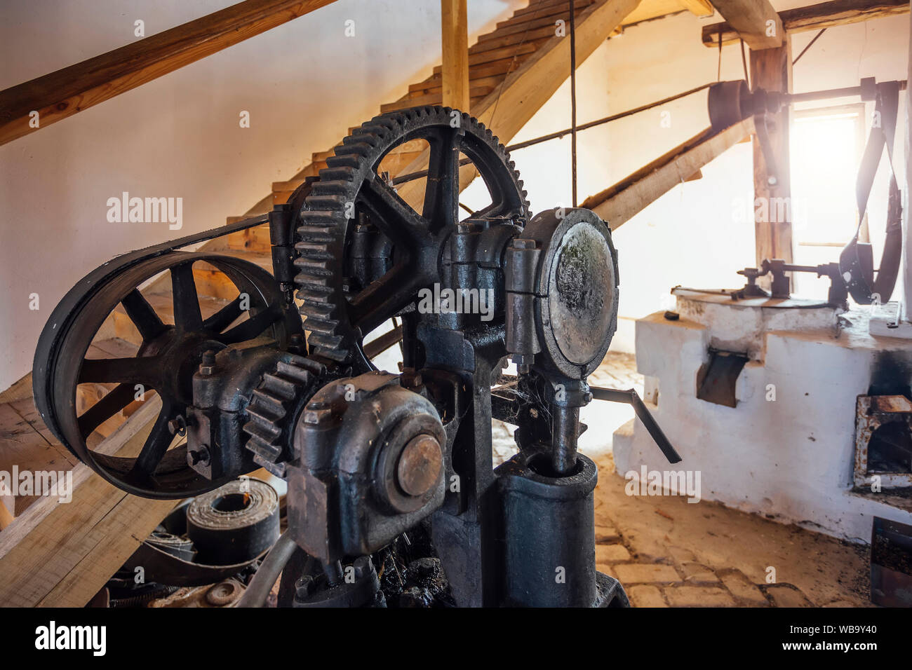Old mechanism. Old gears and pulleys with belt Stock Photo - Alamy