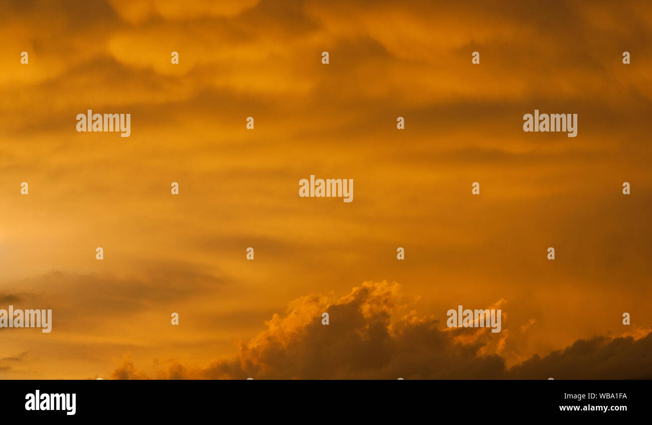 Strange and mysterious sunset sky with golden clouds as alien planet ...