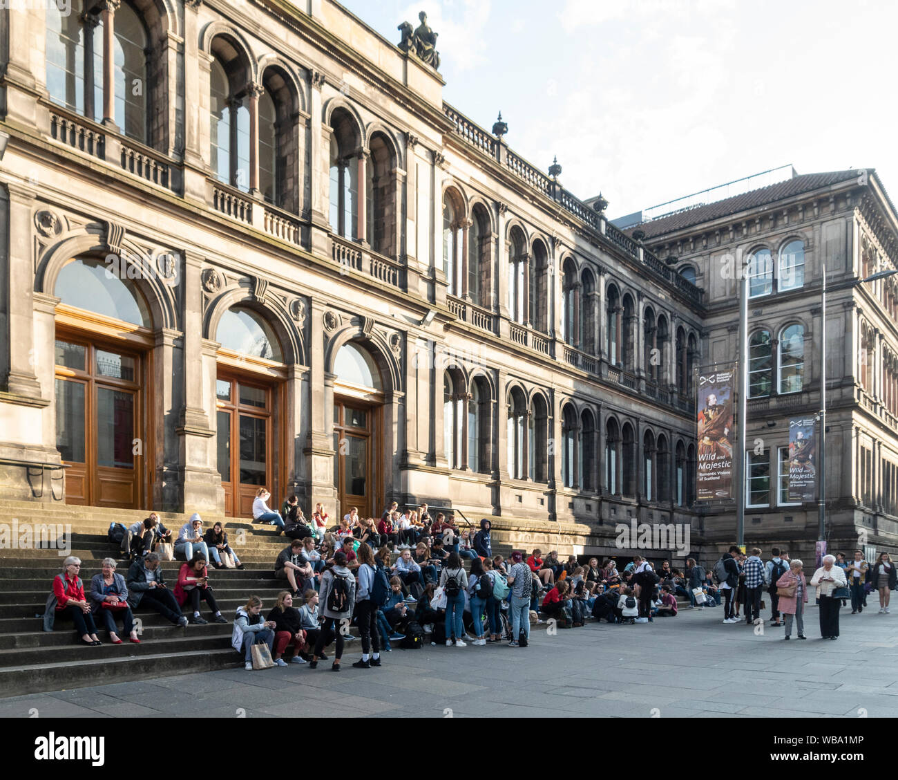 A large group of people outside the main entrance of the National ...
