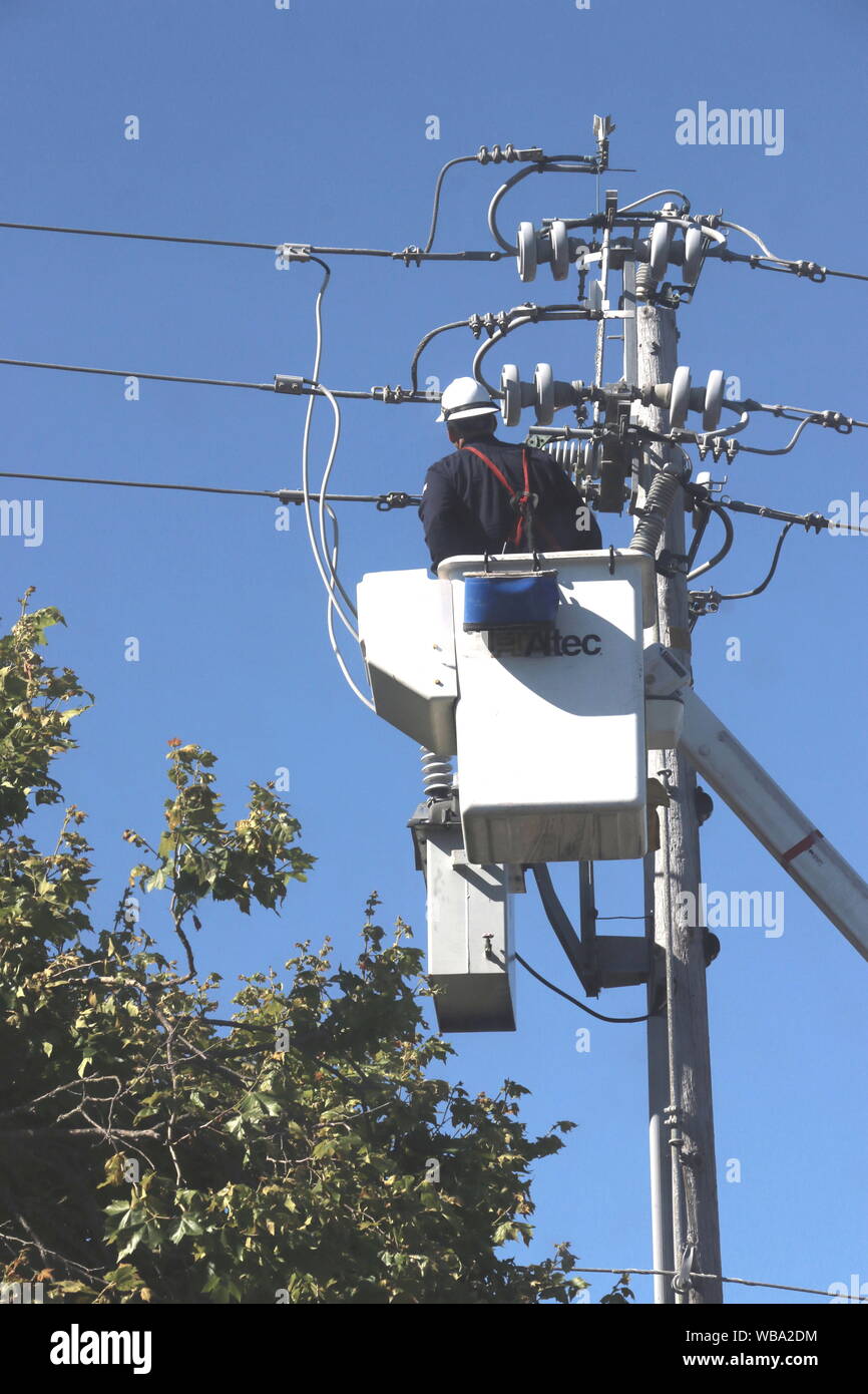 A PG&E repairman repairs an electrical problem after a power outage ...