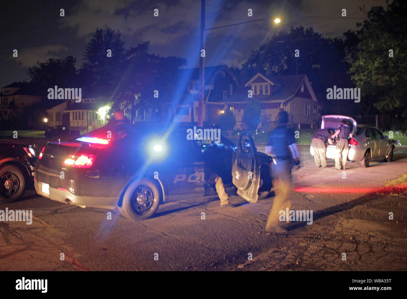 Detroit police search a car after arresting a man with a gun, Detroit ...