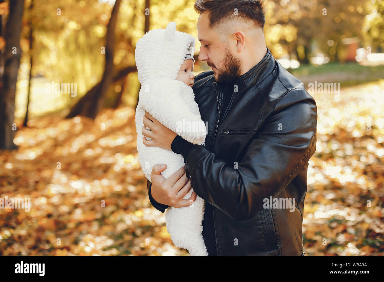 Family with cute son. Father in a black jacket Stock Photo - Alamy