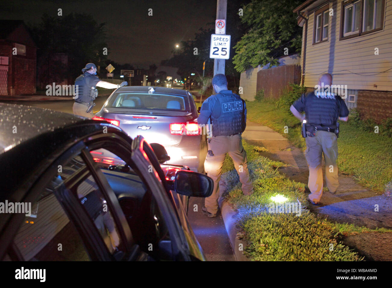 Police in Detroit stop a car at night to speak to the driver, Detroit ...