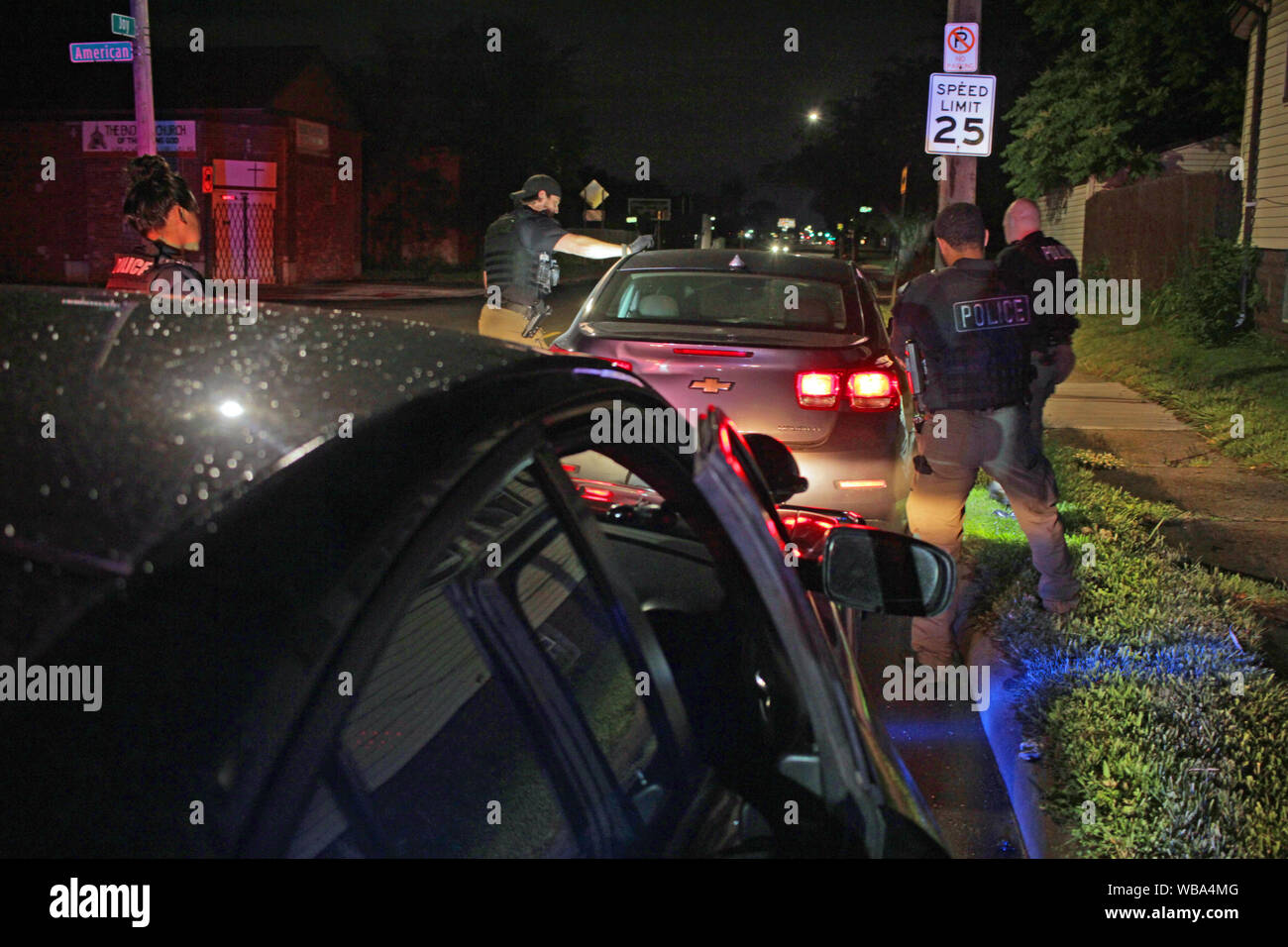 Police in Detroit stop a car at night to speak to the driver, Detroit ...