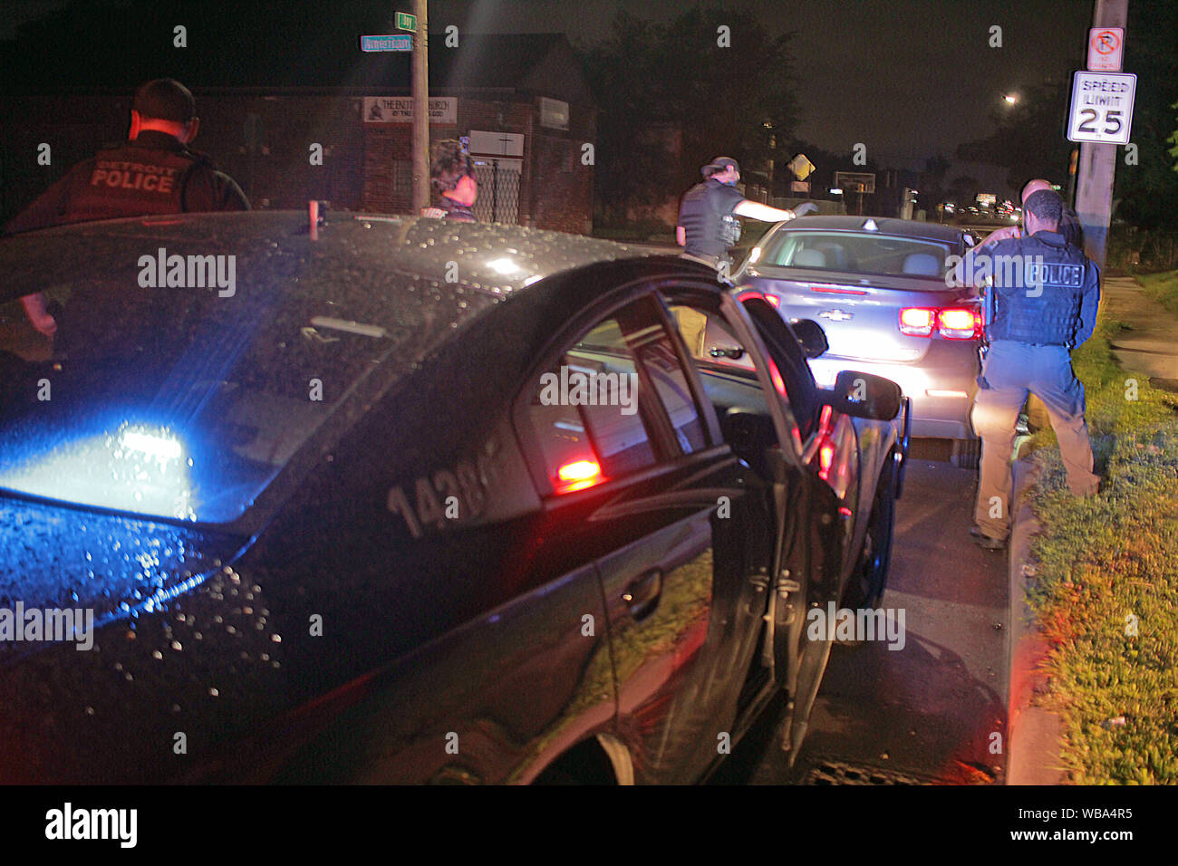 Police in Detroit stop a car at night to speak to the driver, Detroit ...