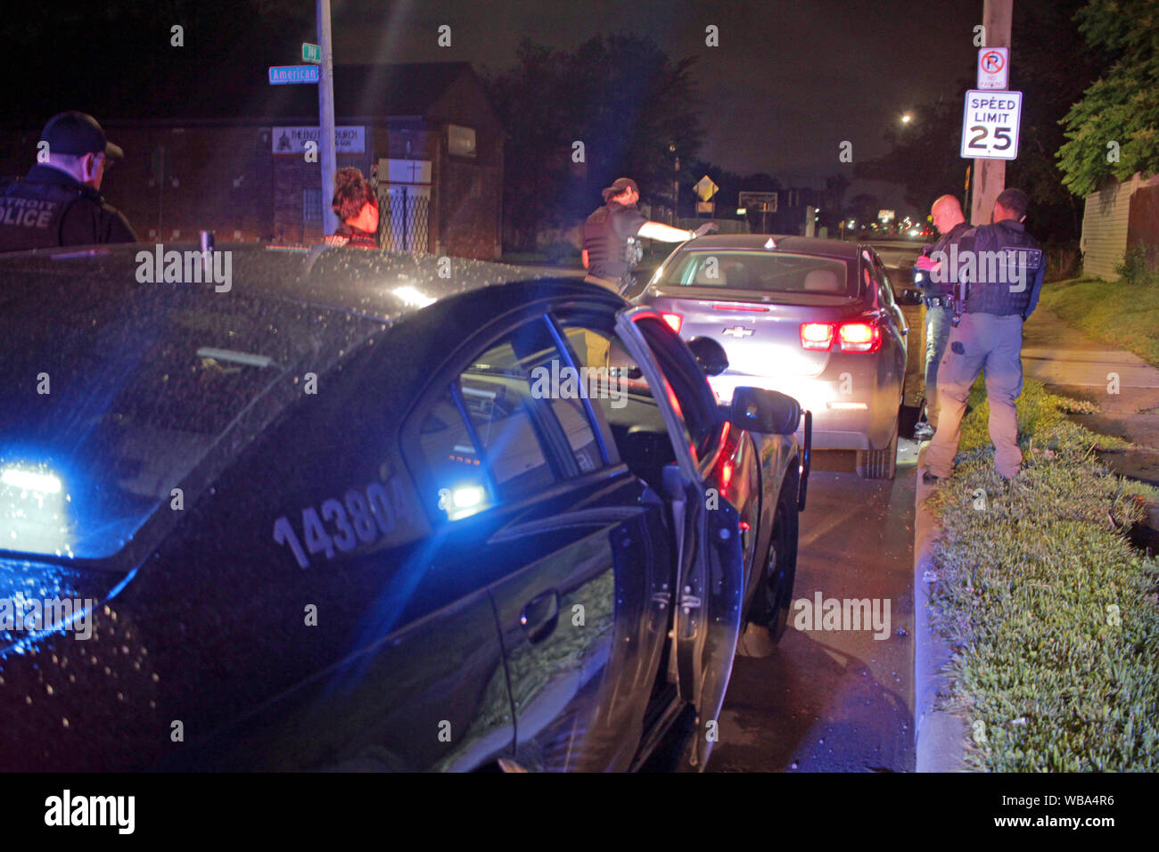 Police in Detroit stop a car at night to speak to the driver, Detroit ...