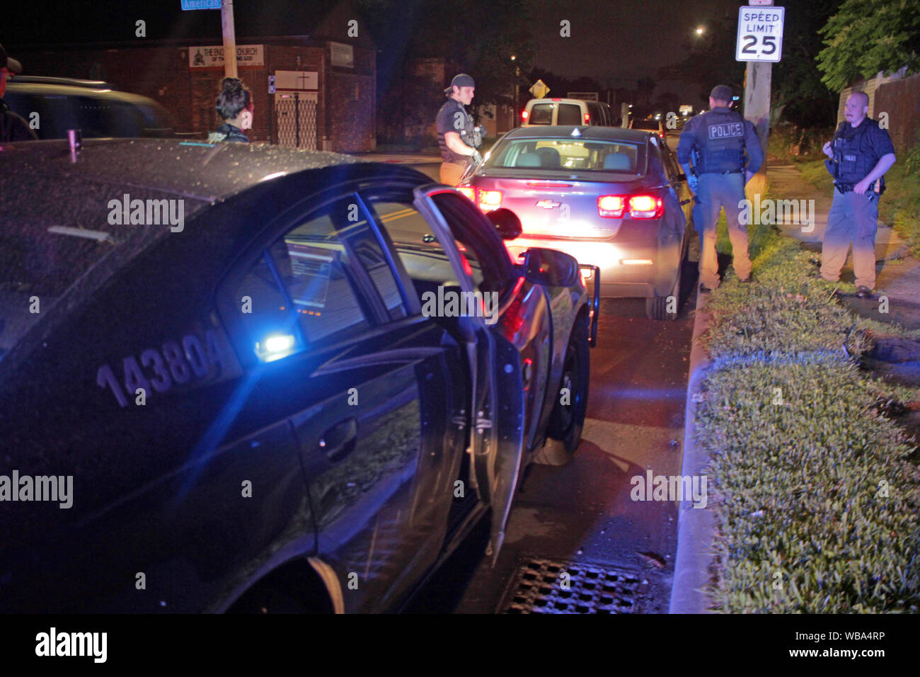 Police in Detroit stop a car at night to speak to the driver, Detroit ...