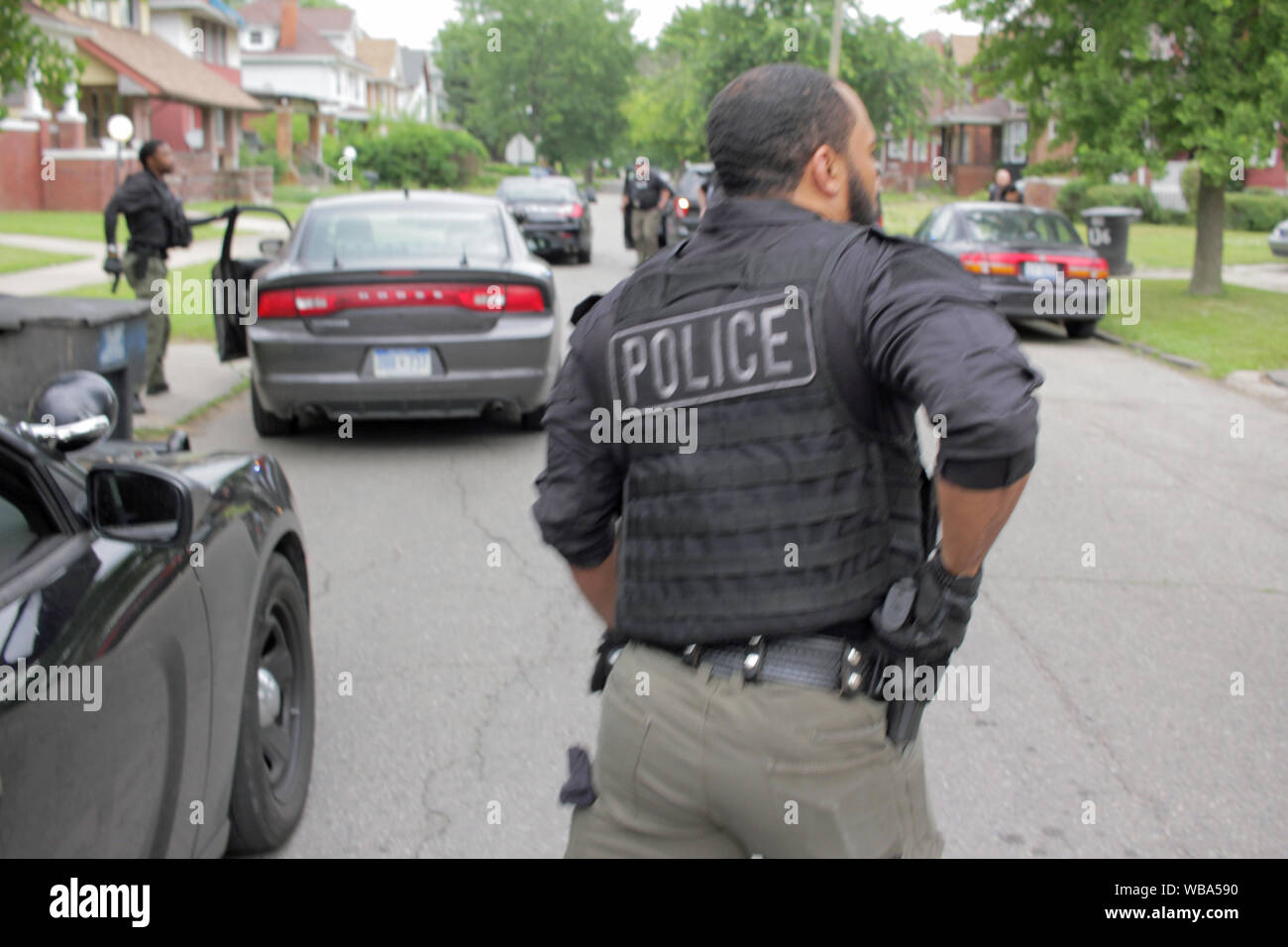 Detroit Police Department Special Operations officer drawers his gun as ...