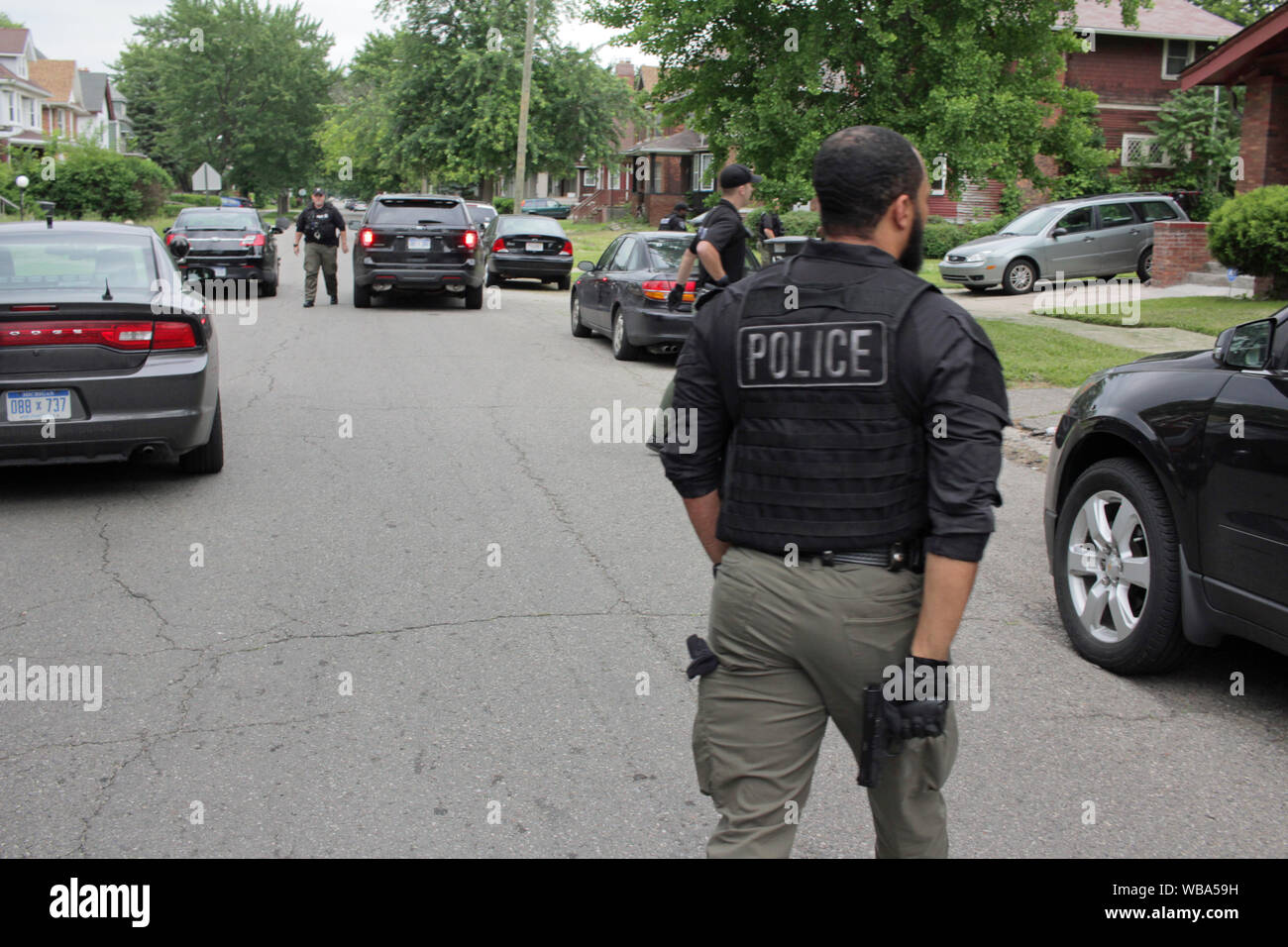 Detroit Police Department Special Operations officer drawers his gun as ...