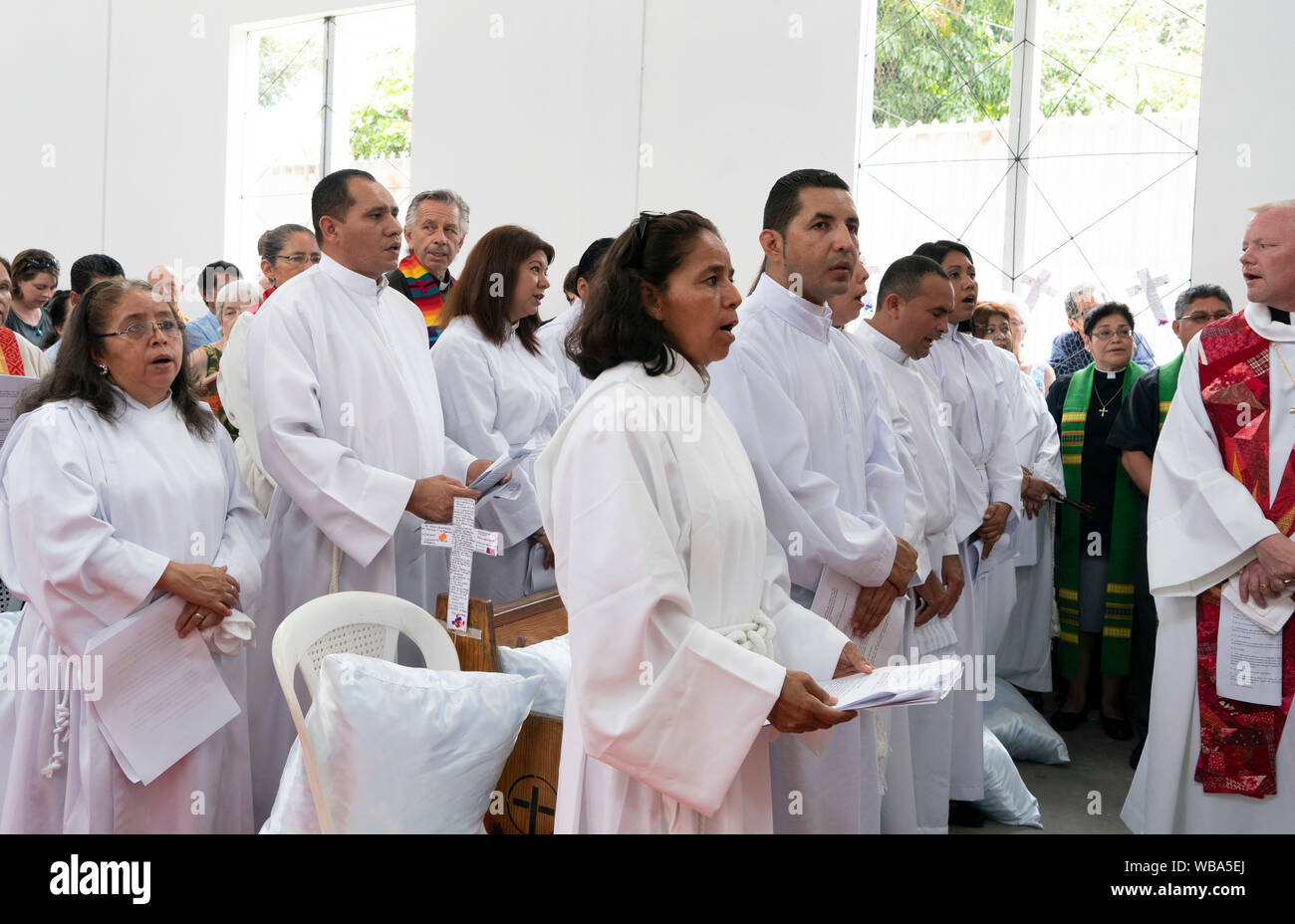 Central American male and female Lutheran seminariansStand to sing a ...