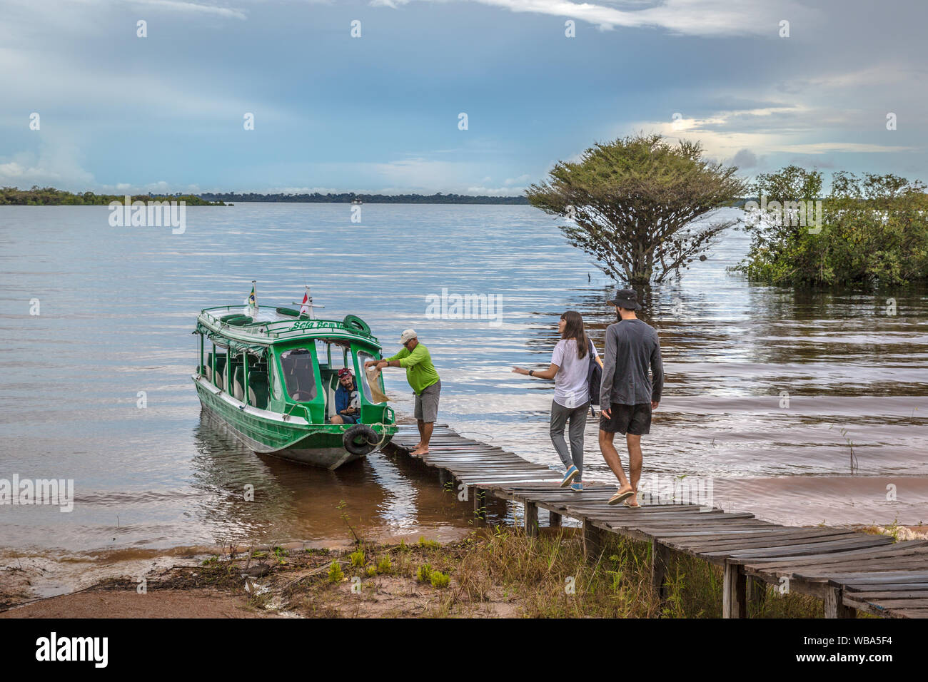 April 4th 2018 - Amazon Forest, Brazil - Tourists walking in a rustic ...