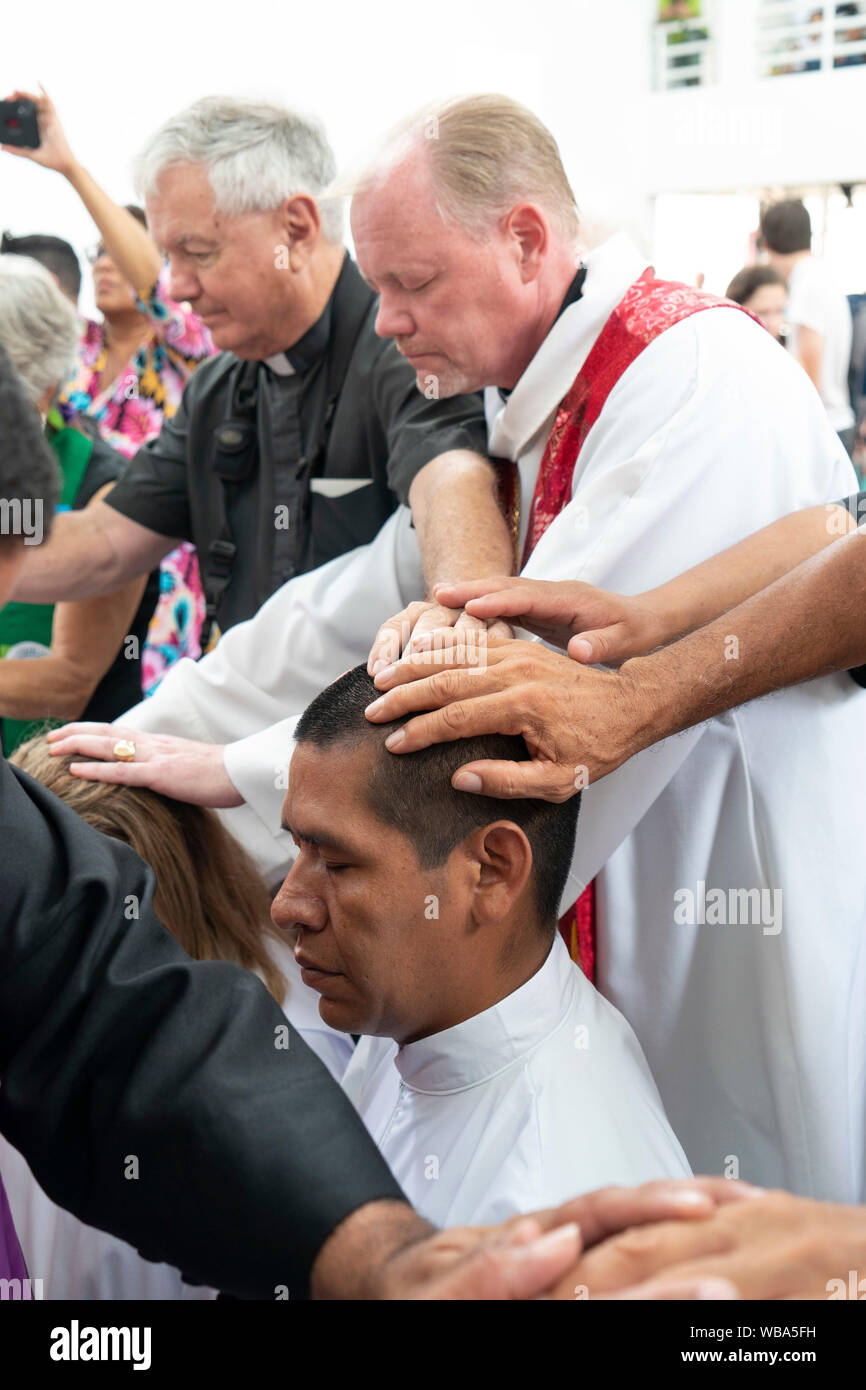 Traditional laying on of hands blessing during ordination ceremony for ...