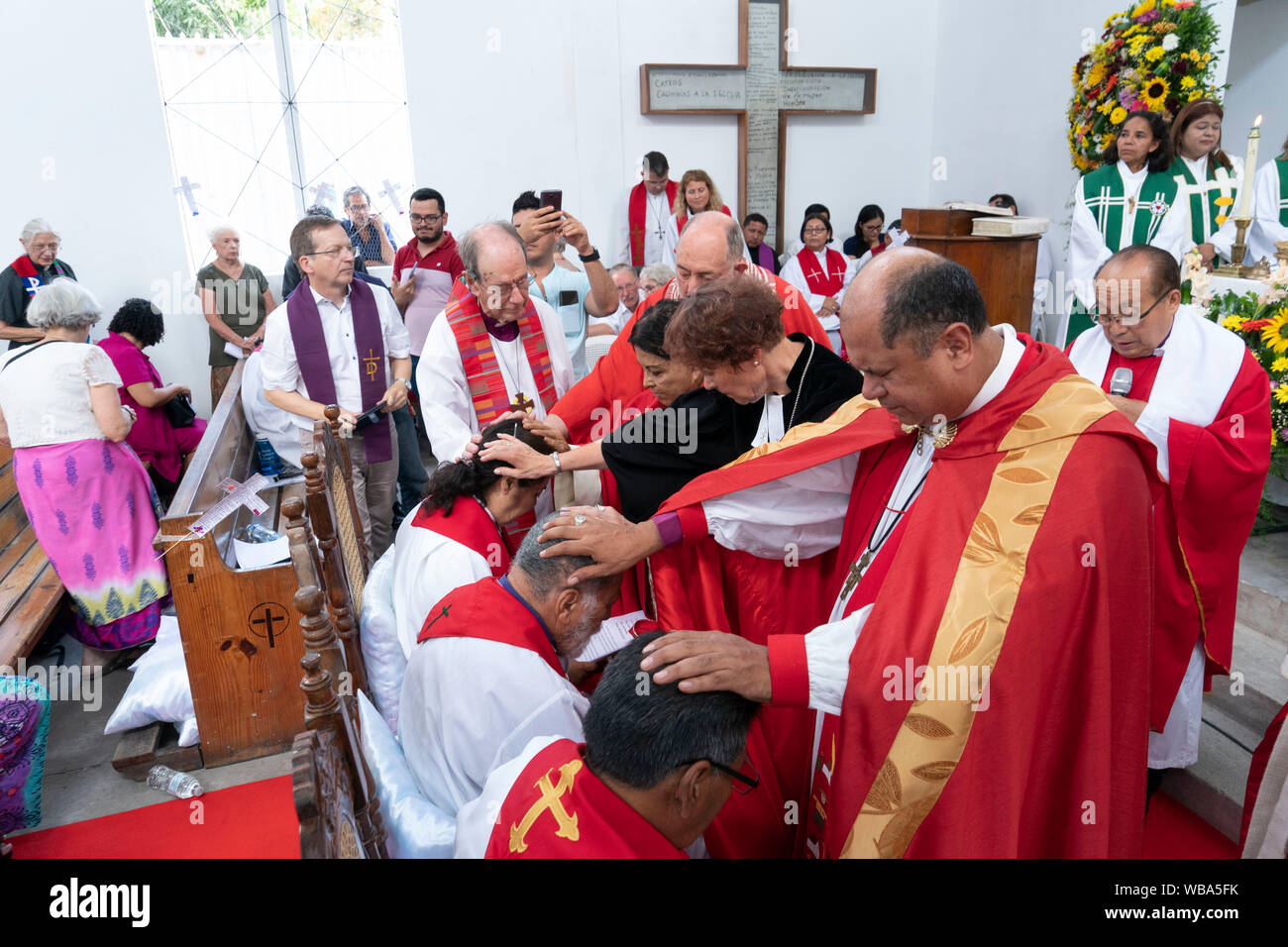 Laying on hands in church hi-res stock photography and images - Alamy