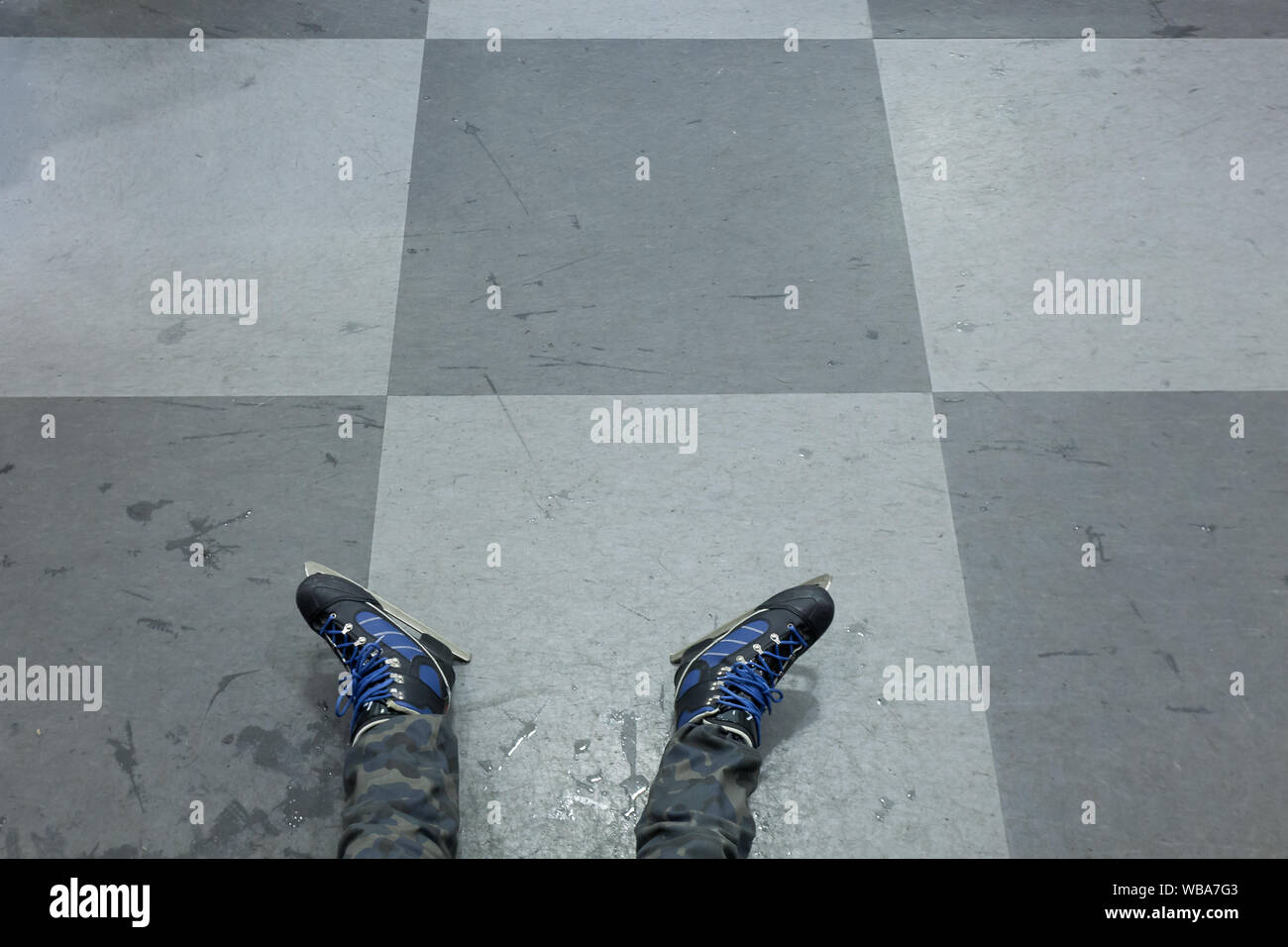 Detail image of the feet and skates of an ice-skater resting Ice ...