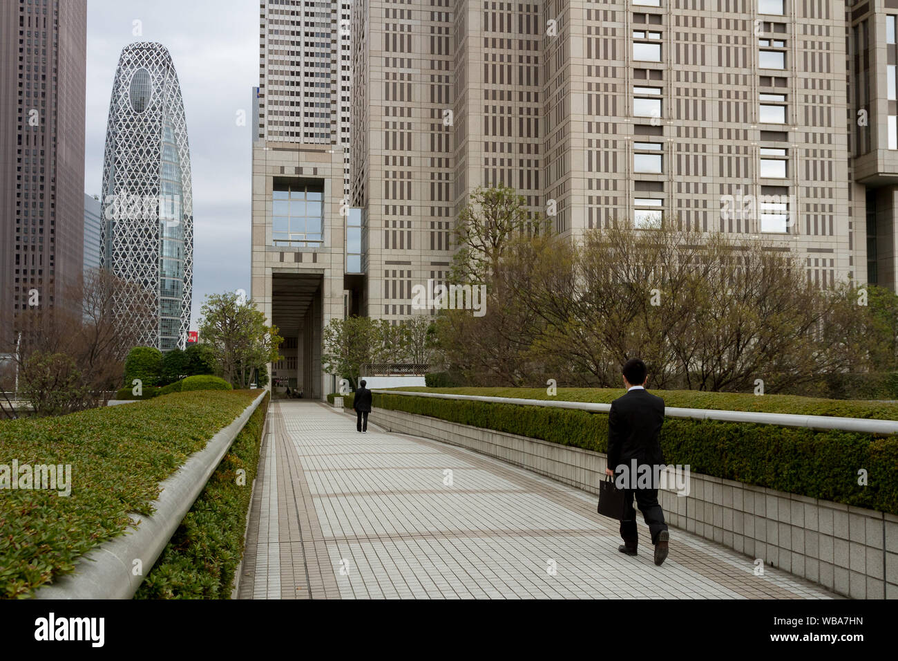 Japanese male office workers, or salarymen in front of the Tokyo ...