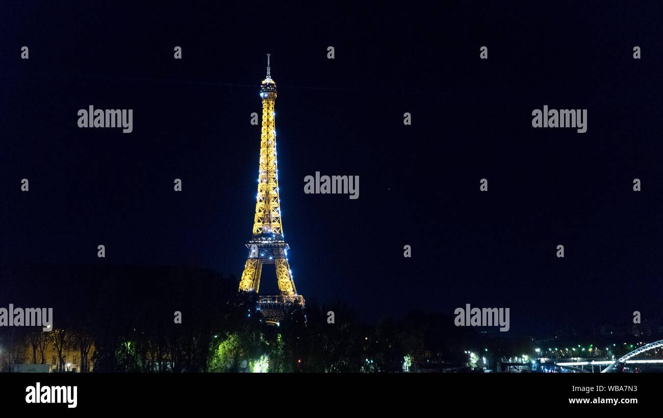 Wide shot of lighted Eiffel Tower at night in Paris, France Stock Photo - Alamy