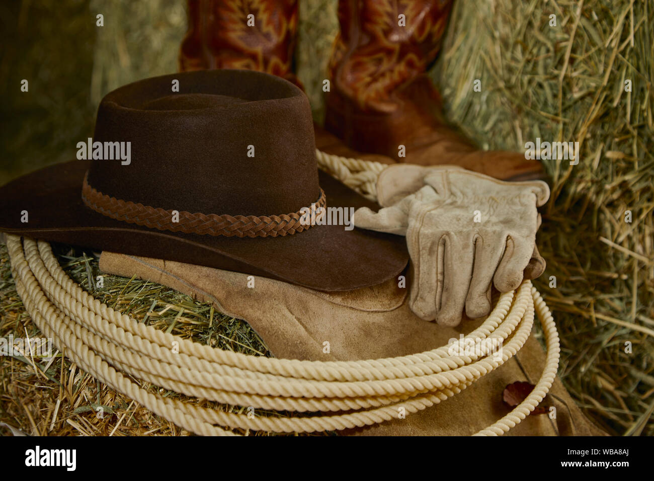 Western lasso with a cowboy hat, leather gloves, cowboy boots and ...