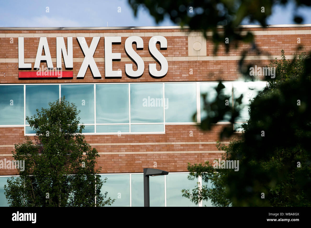 A logo sign outside of a facility occupied by Lanxess ...