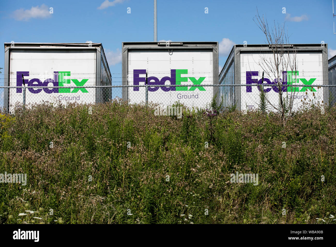 FedEx Ground logos on truck trailers at a FedEx distribution center in ...