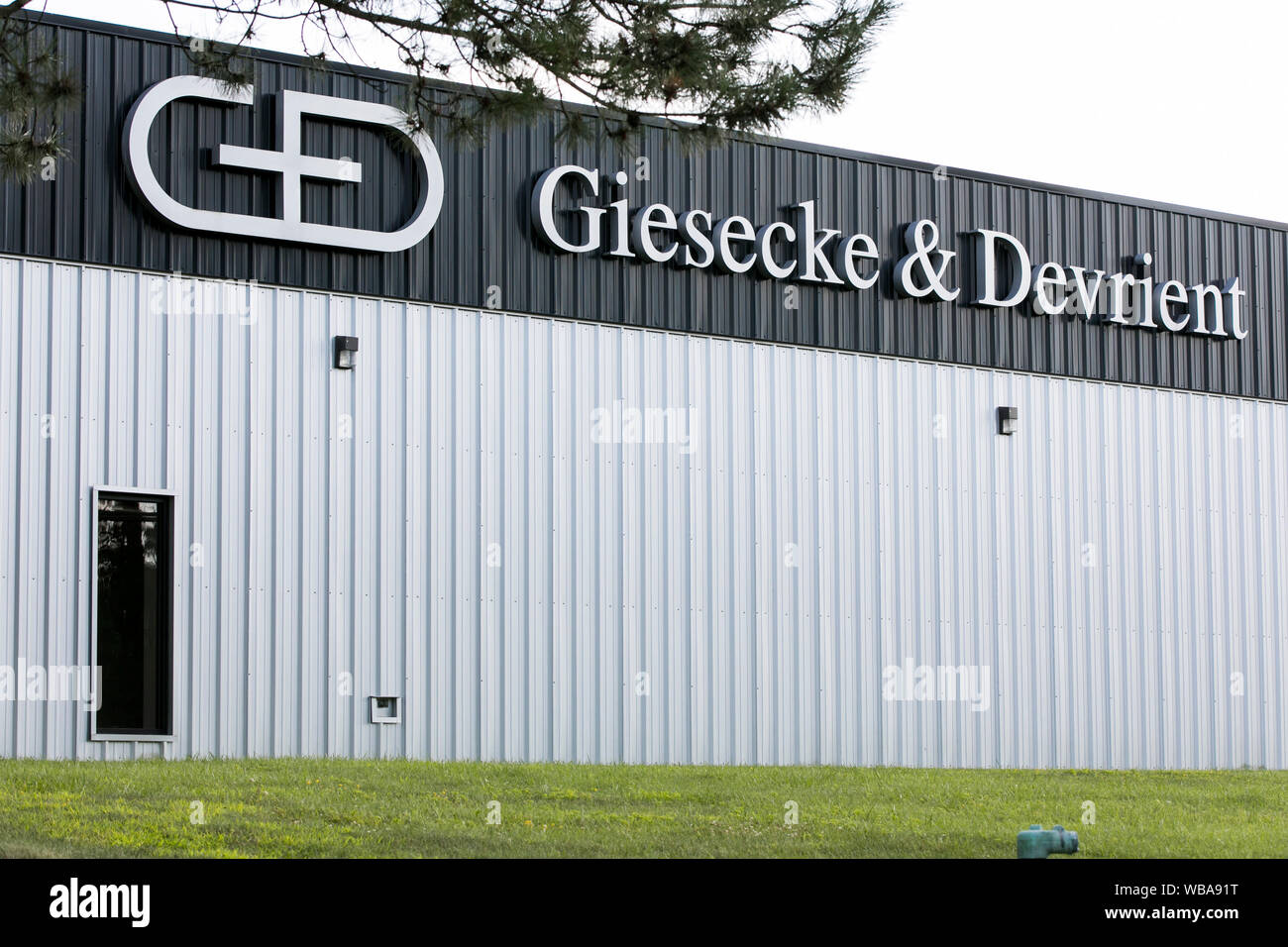 A logo sign outside of a facility occupied by Giesecke and Devrientin ...