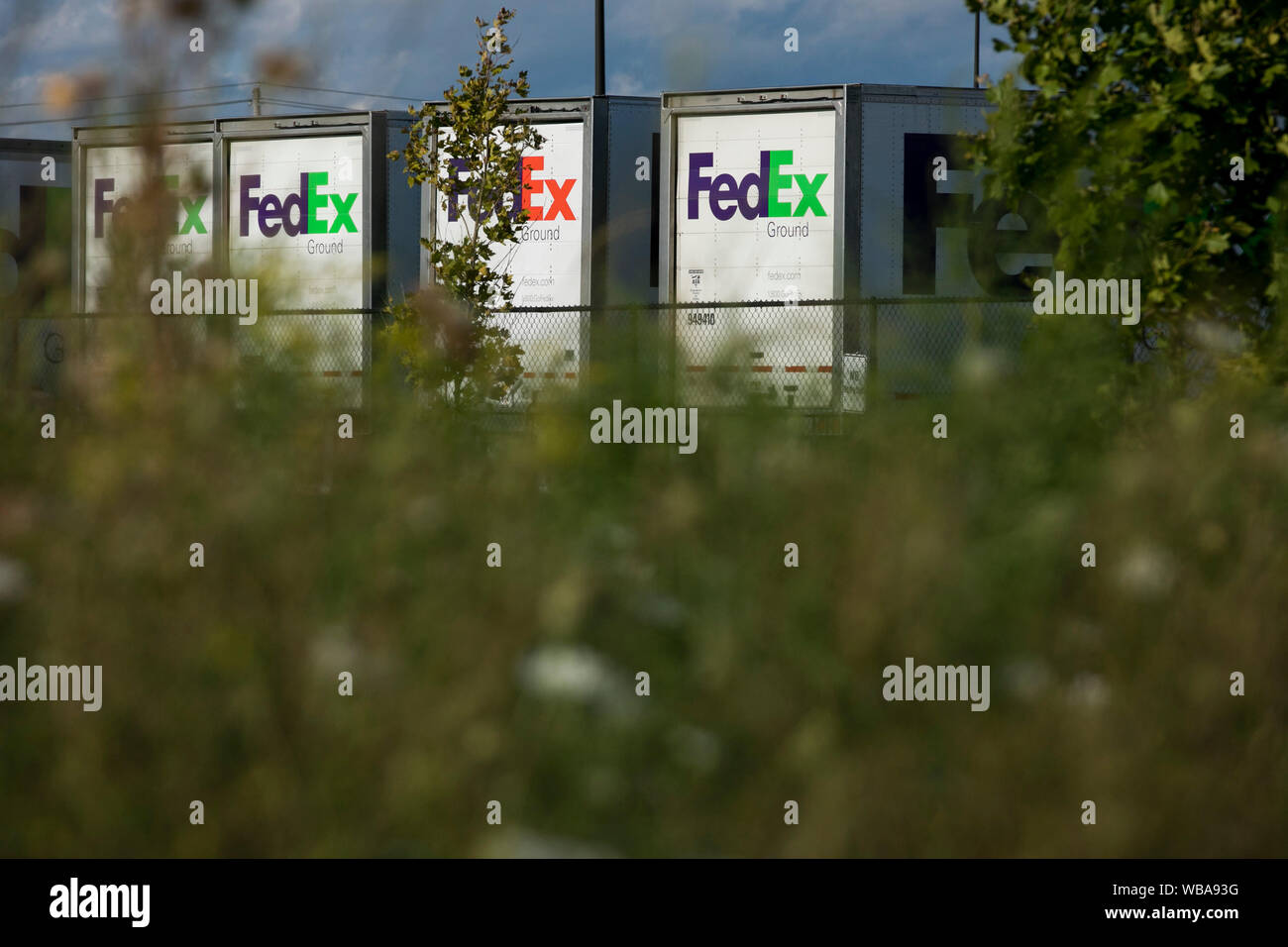 FedEx Ground logos on truck trailers at a FedEx distribution center in ...