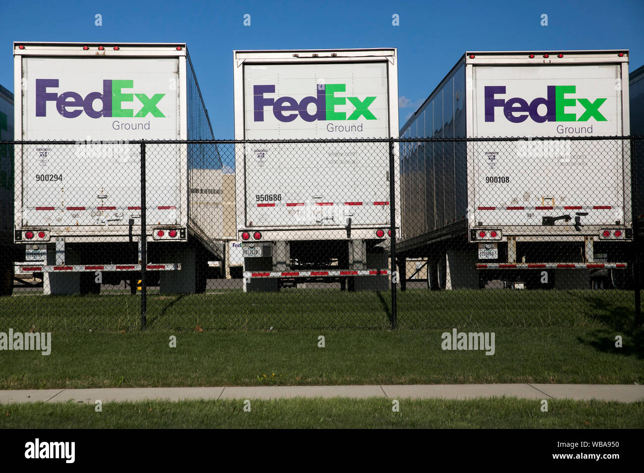 FedEx Ground logos on truck trailers at a FedEx distribution center in ...