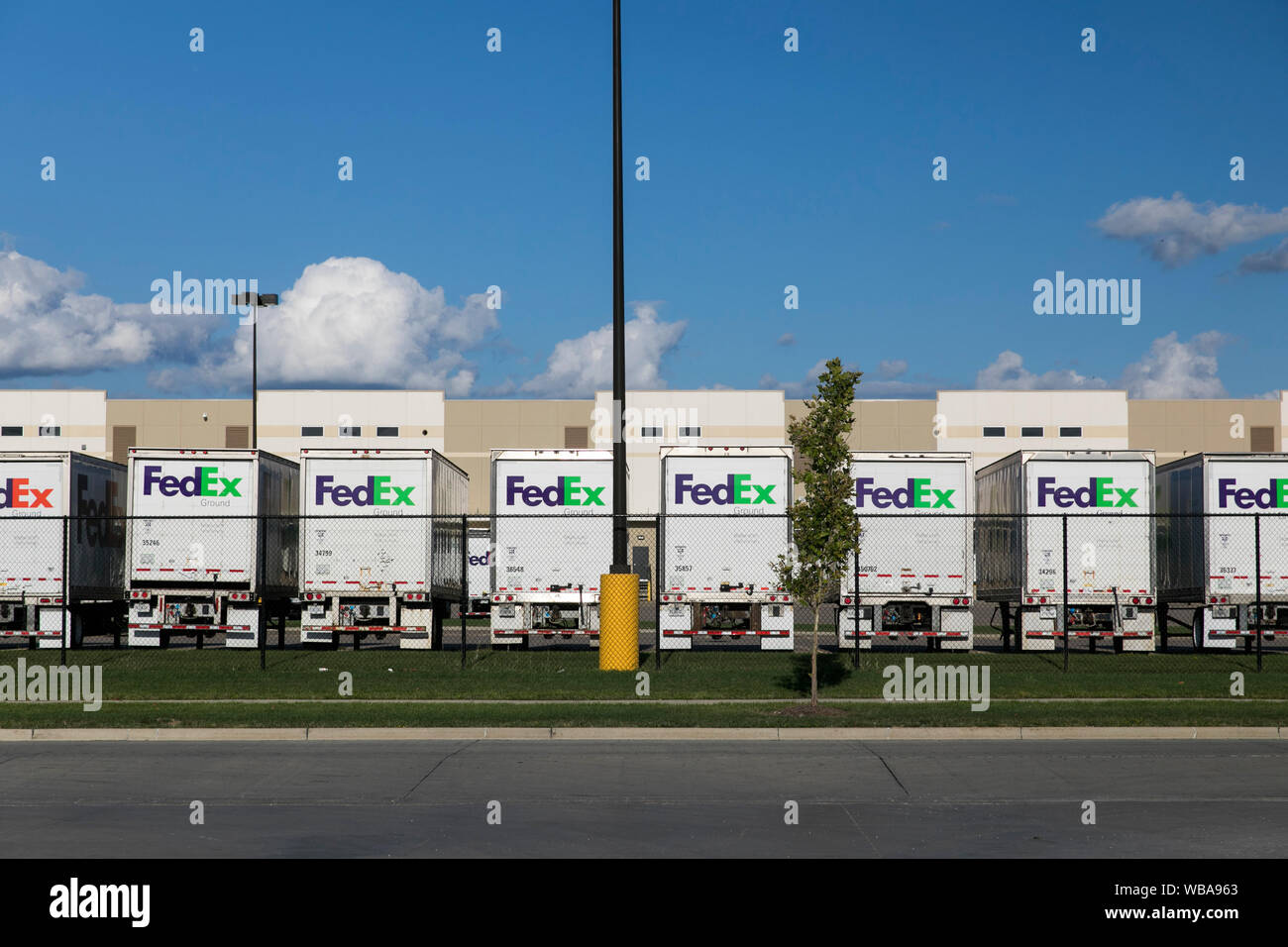 FedEx Ground logos on truck trailers at a FedEx distribution center in ...