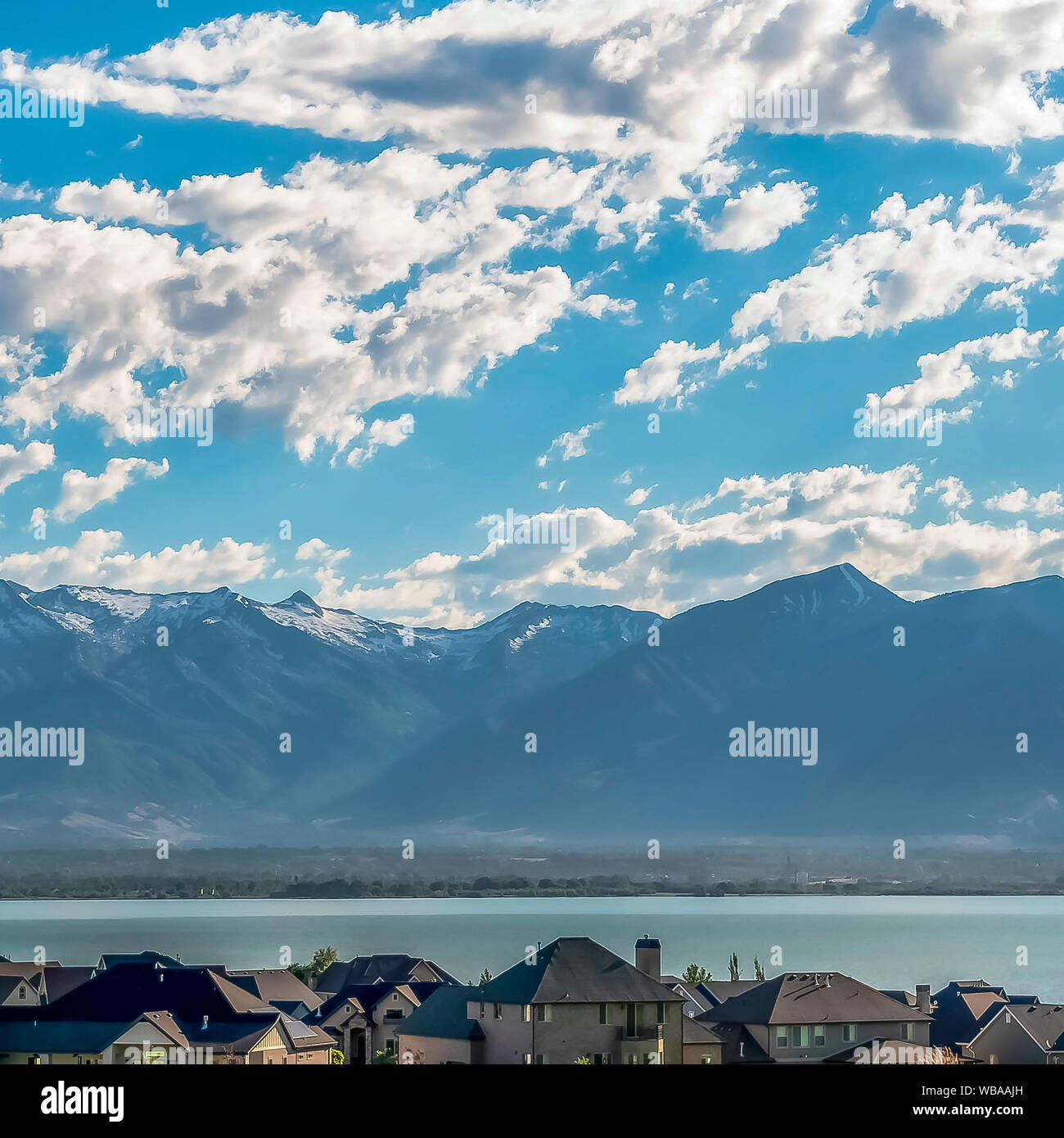 Square Picturesque landscape with homes overlooking a blue lake and ...