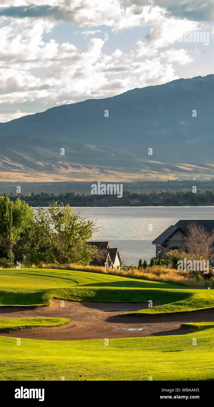 Vertical Golf course hazard and fairway with houses and lake in the ...