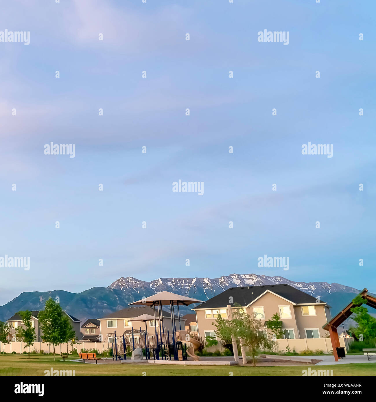 Square Scenic view of a neighborhood with towering mountain and cloudy ...