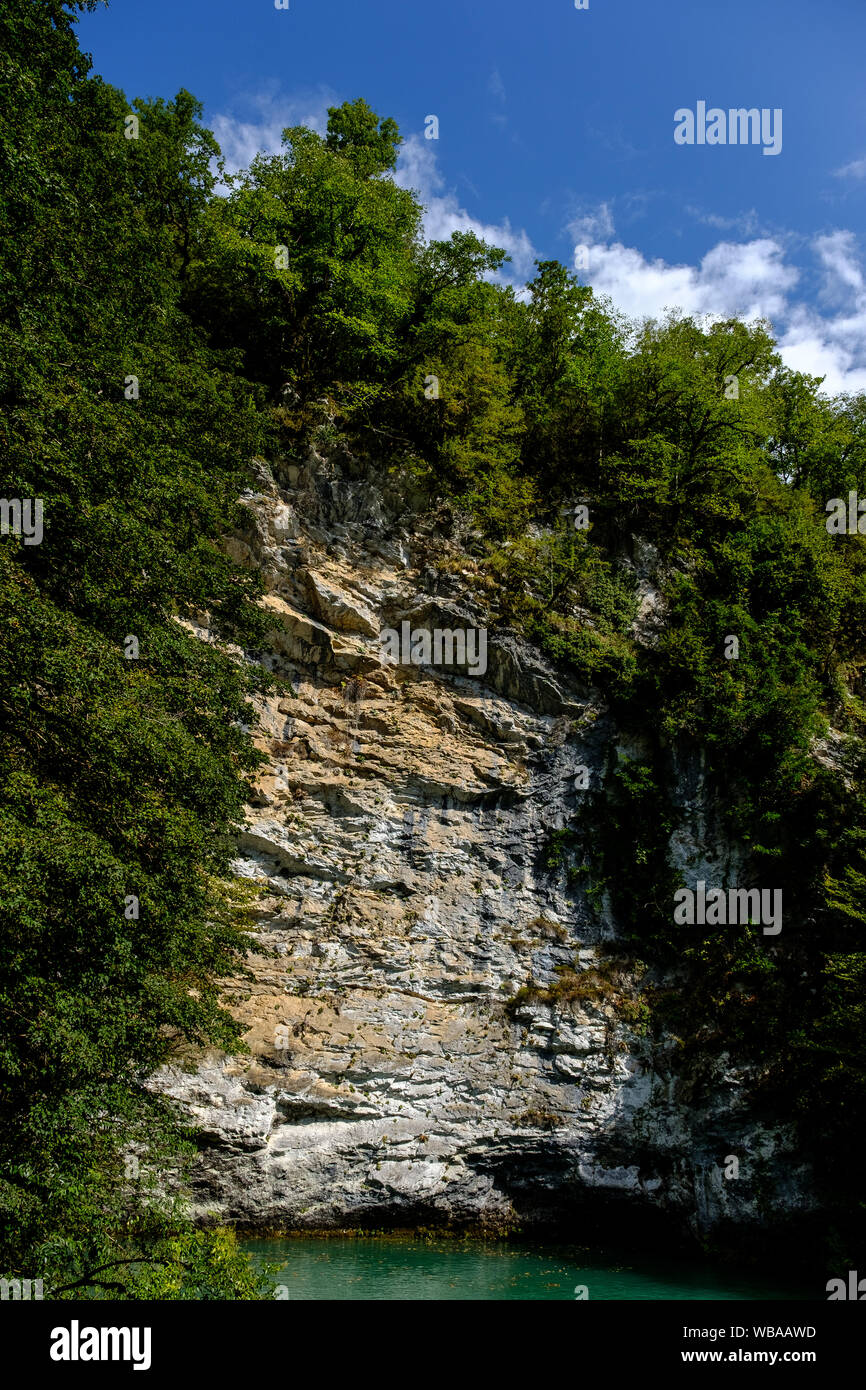 Mountain lake under the cliff in sunny day Stock Photo - Alamy