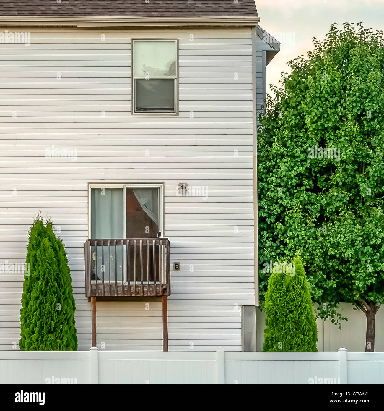 Square frame Facade of home with white wall bay window small balcony ...