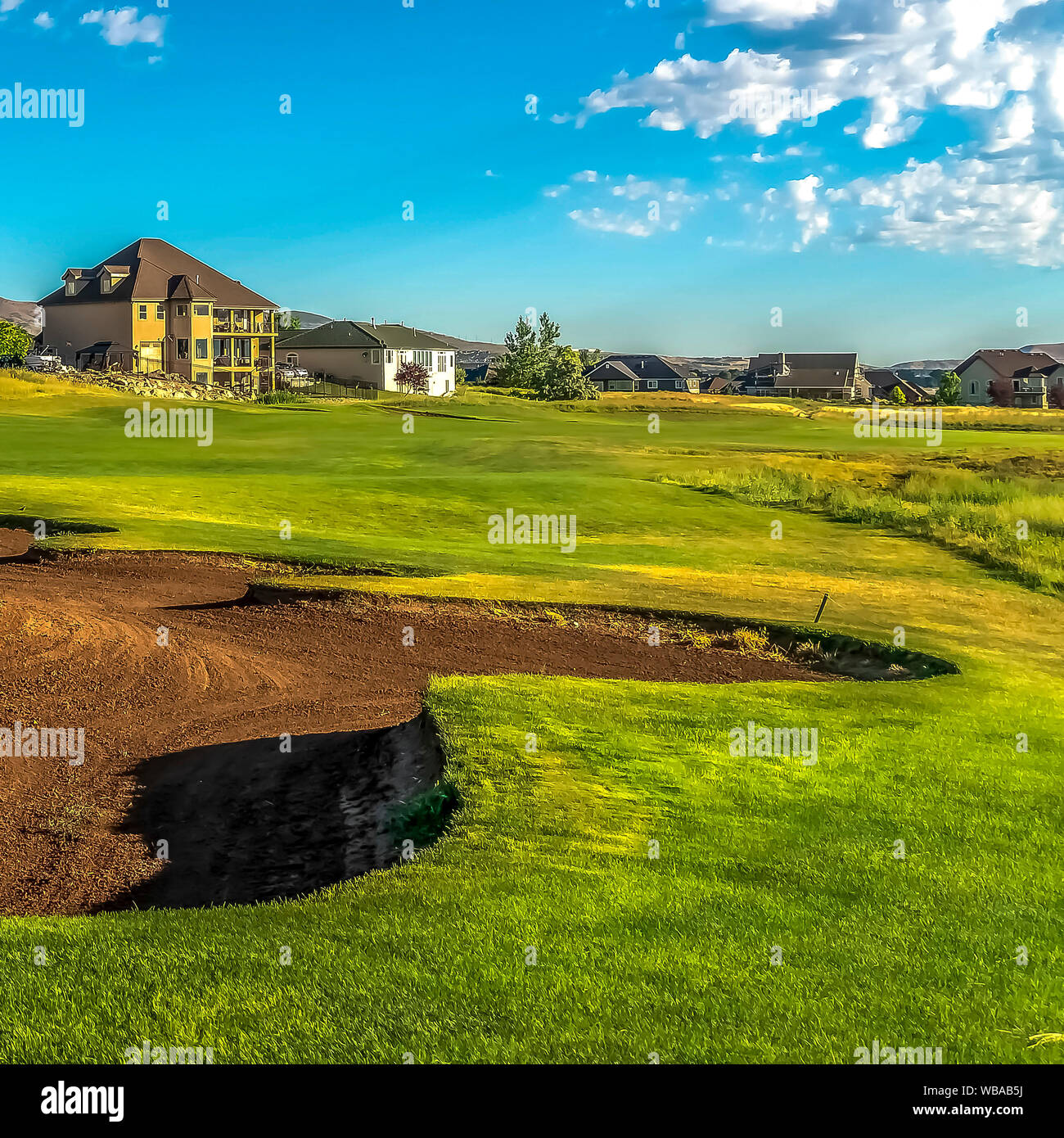 Square frame Sand bunker and fairway of a golf course with residential ...