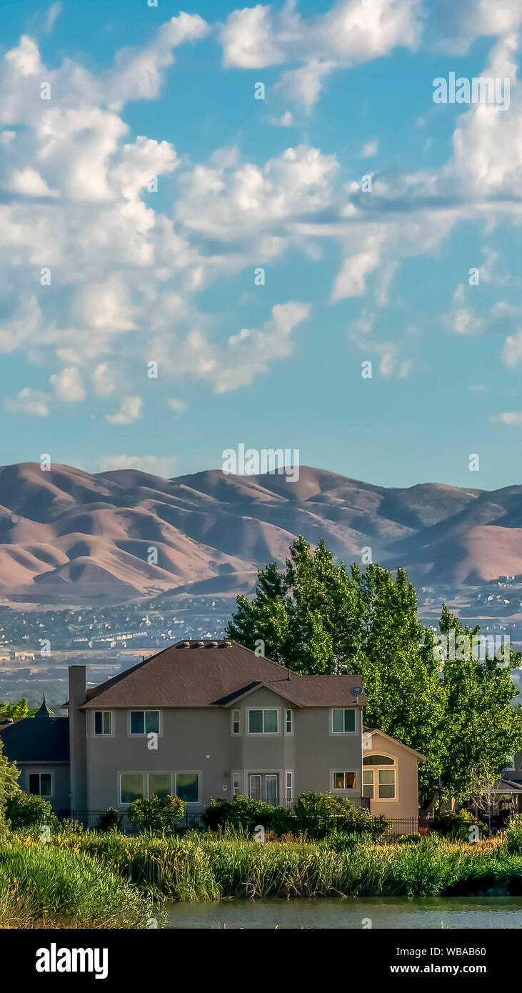 Vertical Pond and grassy terrain in front of houses with view of the ...
