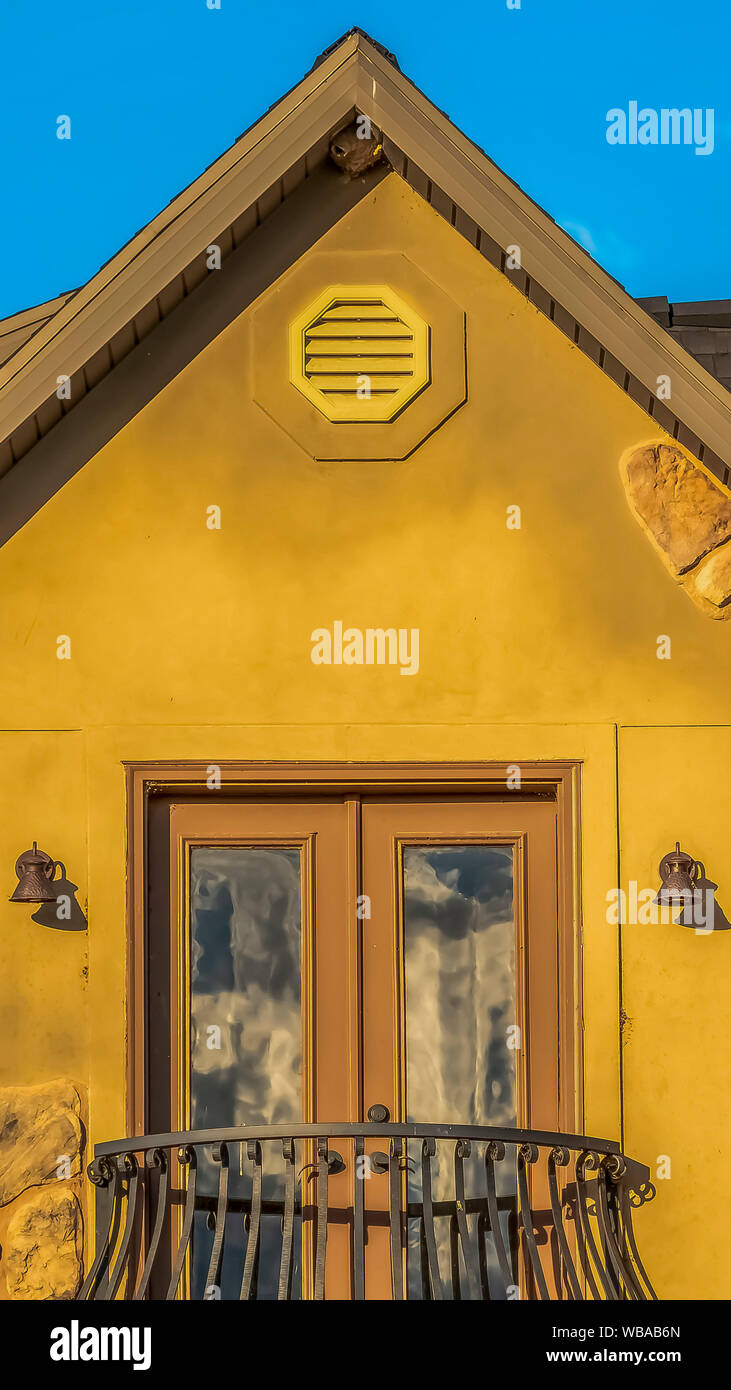 Vertical Close up of the half circular balcony of a home with double ...