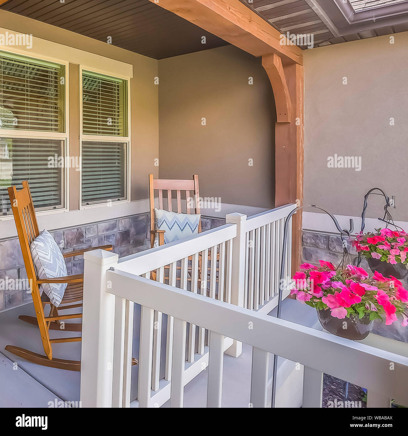 Square frame Facade of a home with rocking chairs on the porch and ...