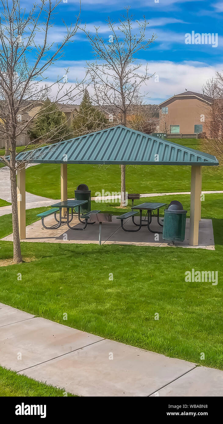 Vertical Small picnic area and curving pathways on a park covered with ...