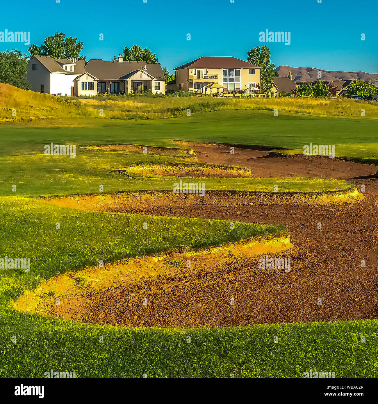 Square frame Sand bunker and fairway of a golf course with residential ...